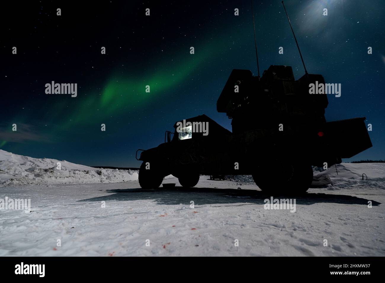 The northern lights glow above an Avenger Air Defense System assigned ...