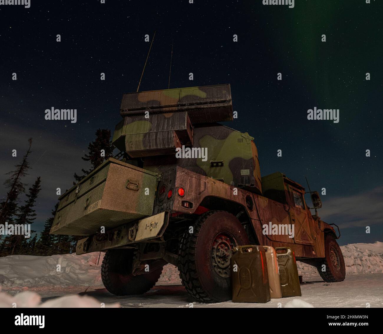 The northern lights glow above an Avenger Air Defense System assigned ...