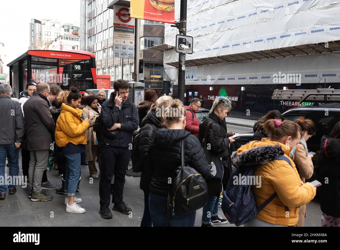 Passengers looking for alternative means of transport gather around a ...