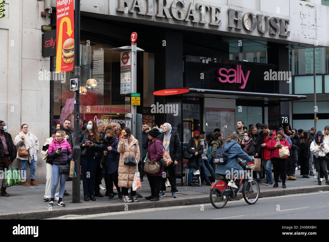 Passengers looking for alternative means of transport gather around a ...