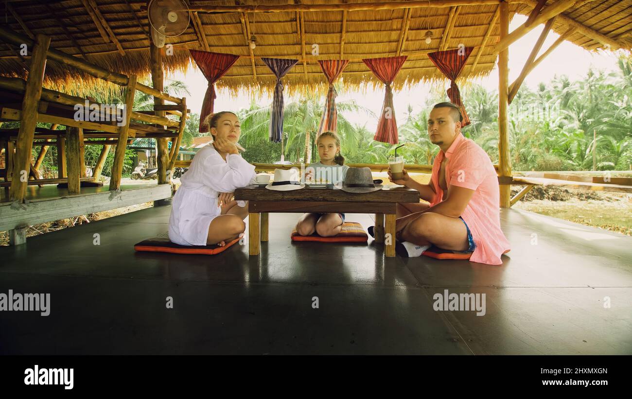 The happy family eat and drink tasty beverages spending time in local ...