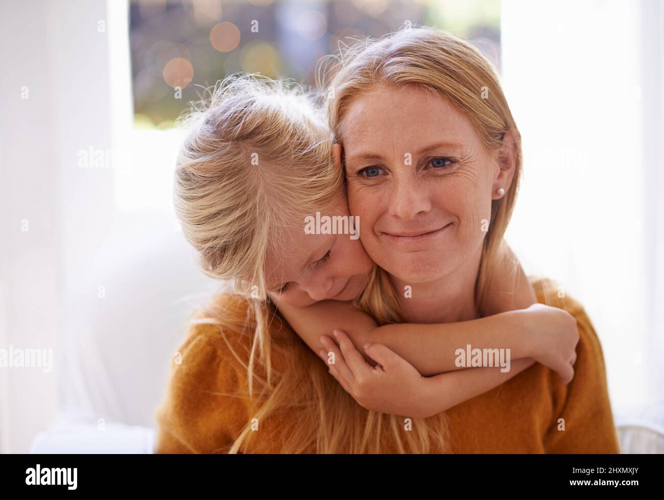 The joys of motherhood. Cropped shot of a little girl hugging her ...
