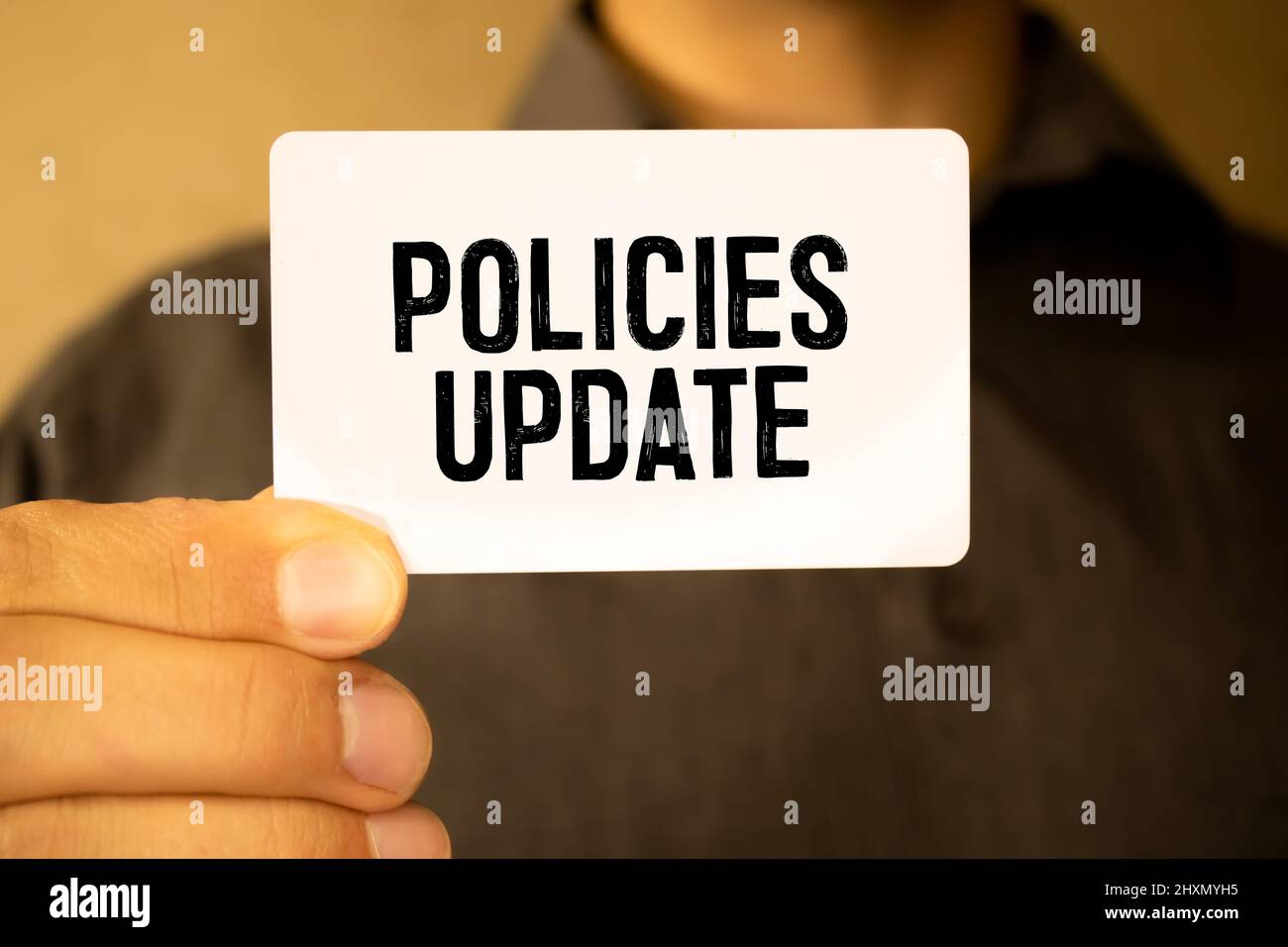Businessman hand showing card with Policies Update message Stock Photo ... Businessman hand showing card with Policies Update message Stock Photo ...