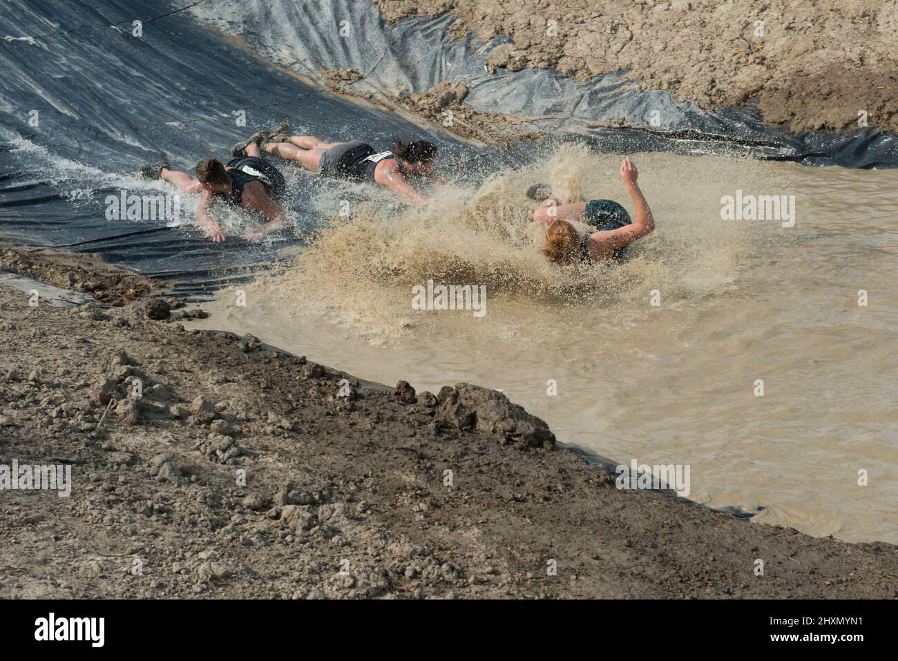 Runner #1986 leads to other competitors into the Swampfoot Run mud pit ...