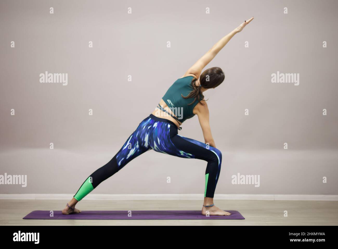 Fitness instructor practicing yoga. Fit girl exercise stretching poses ...