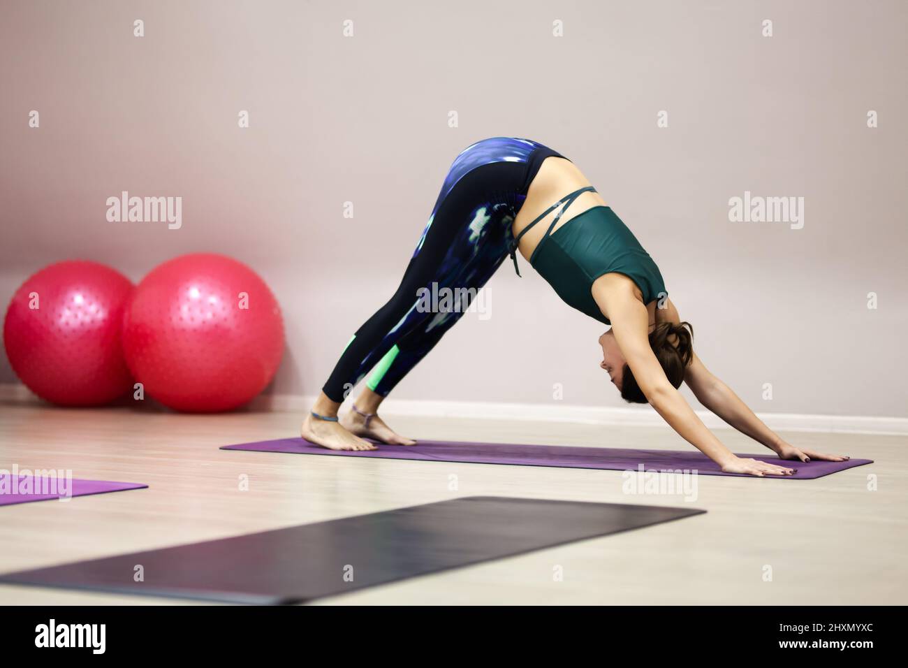 Fitness instructor practicing yoga. Fit girl exercise stretching poses ...