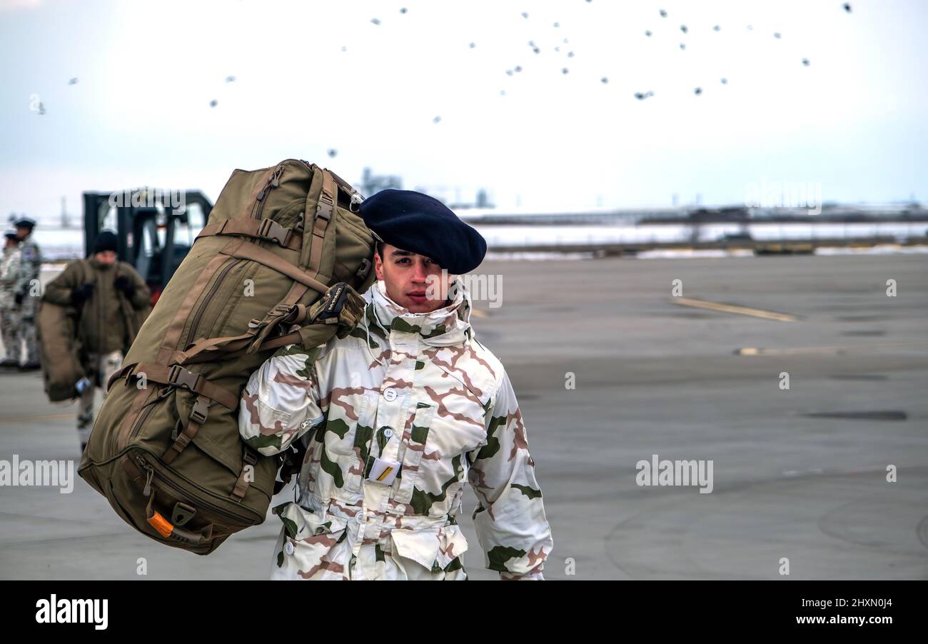 French soldier carries luggage. French military personnel and vehicles ...