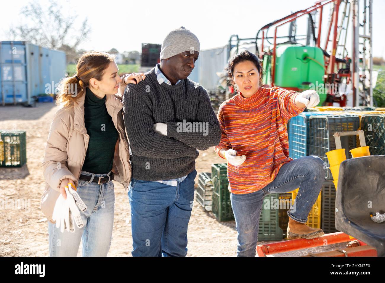 Positive multiracial group of farmers talking in farm backyard Stock ...
