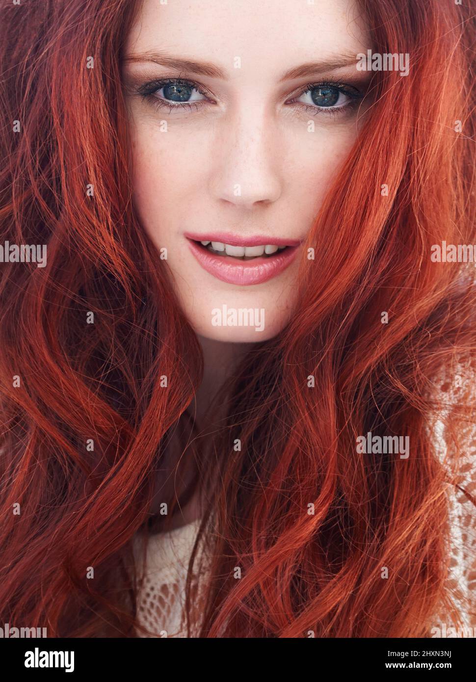 She has fire in her eyes. A young redheaded woman smiling at the camera ...