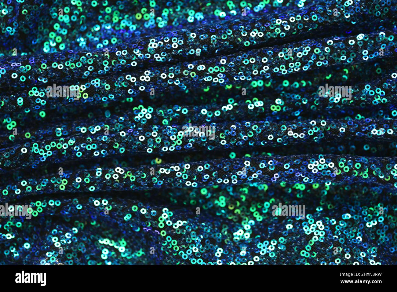 Sequins background.Fabric with shimmery sequins.Green and blue sequins ...