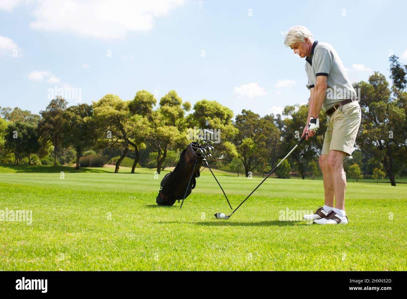 Getting his stance just right.... Senior man getting ready to swing on ...