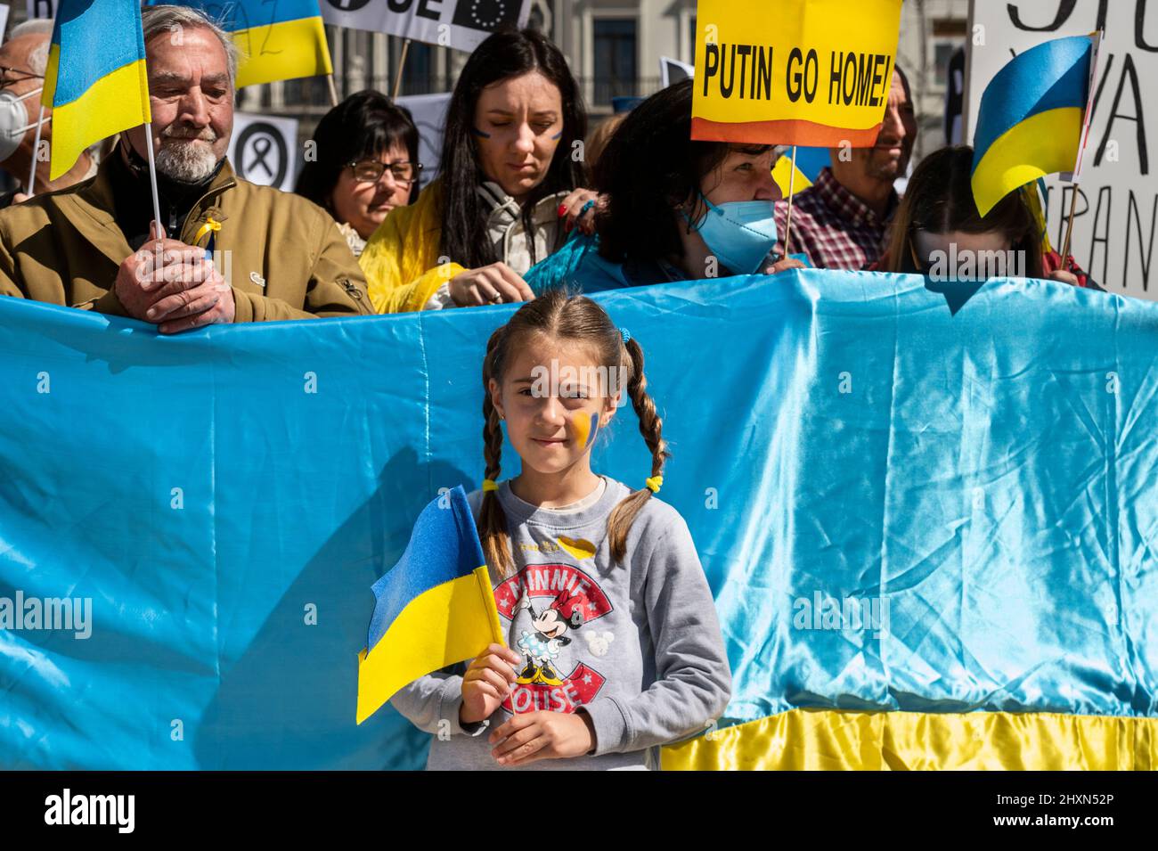 Madrid, Spain. 13th Mar, 2022. A child seen holding a Ukrainian flag ...