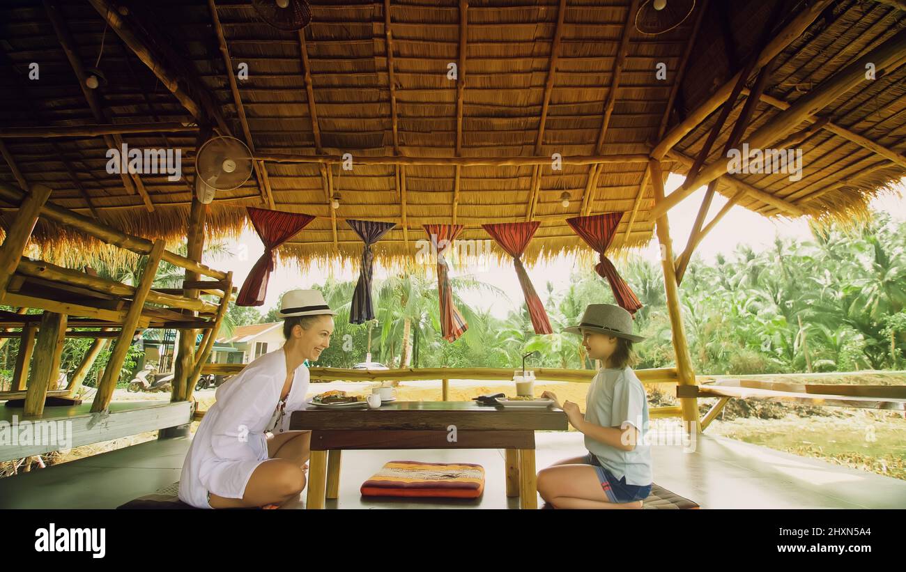 The happy family eat and drink tasty beverages spending time in local ...