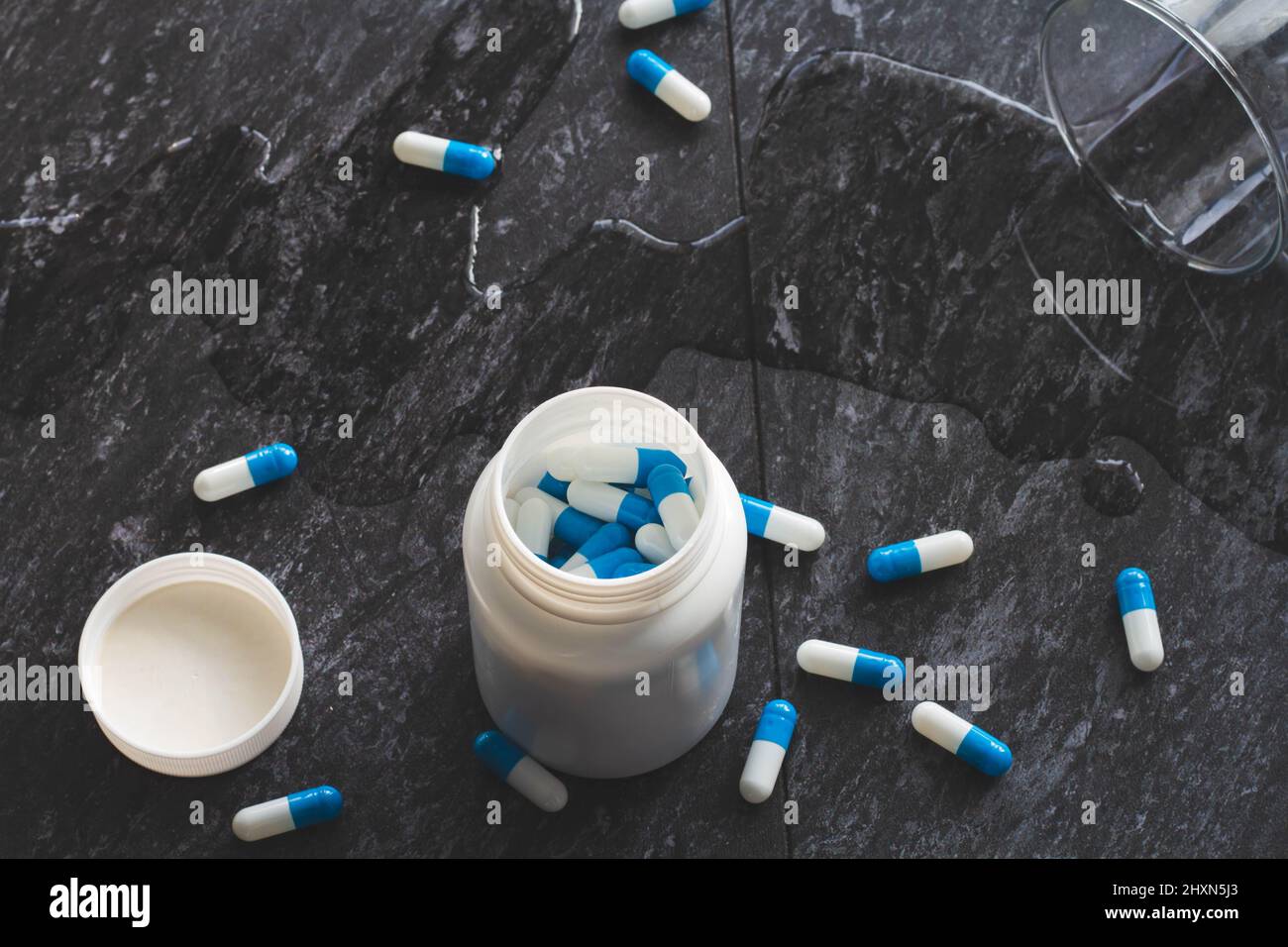 Tablets. Dropping pills and a glass of water from the hands Stock Photo ...