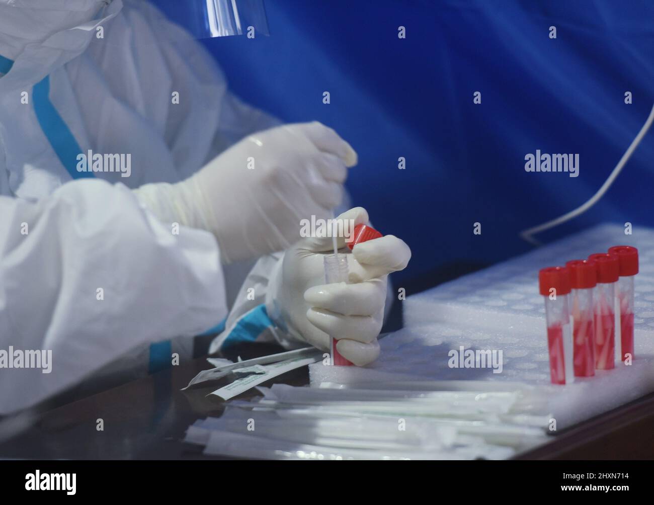 HANGZHOU, CHINA - MARCH 14, 2022 - A medical worker puts a nucleic acid ...