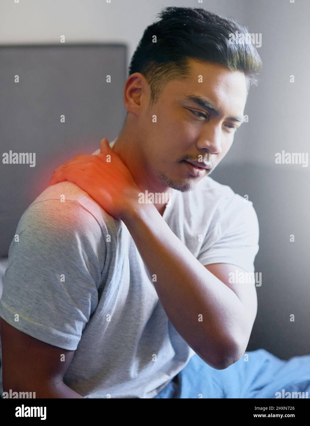 Maybe I overdid it at the gym yesterday.... Shot of a young man rubbing ...