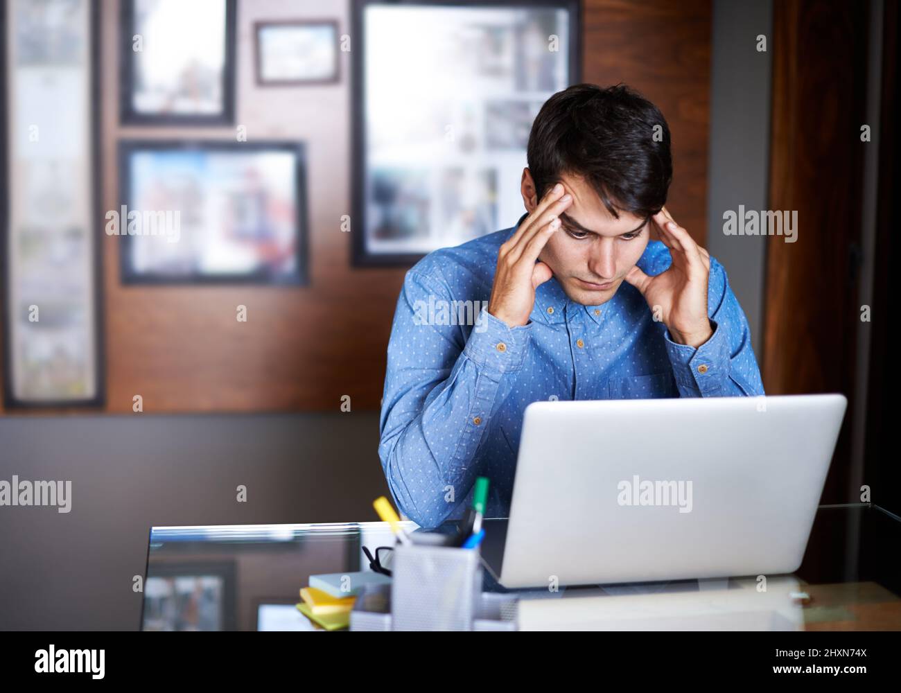Im stuck.... A young businessman looking frustrated while sitting at ...