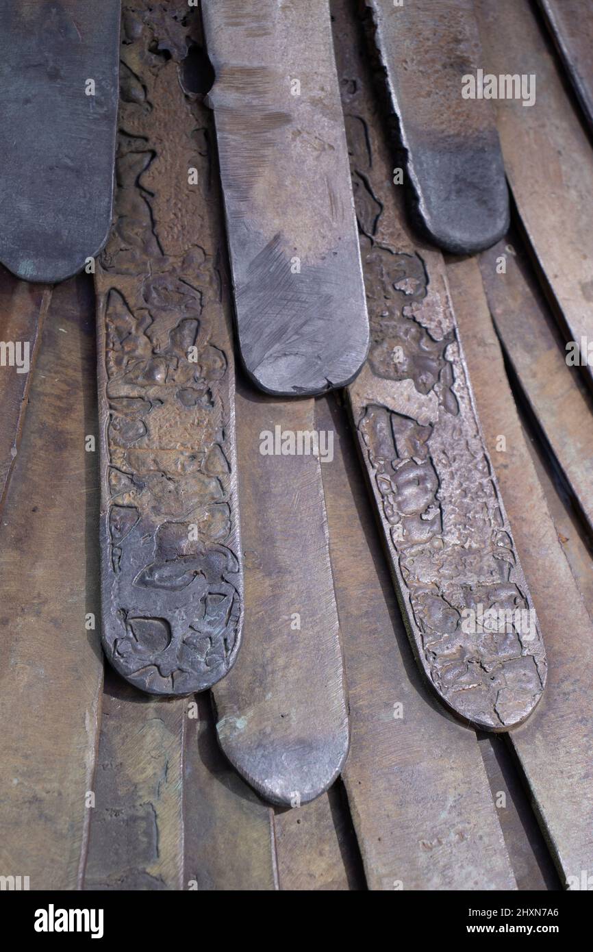 Bronze sculpture that looks like scales and has textured surfaces Stock ...