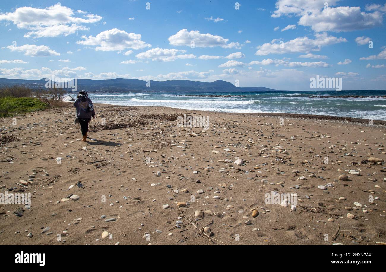 Paphos, Cyprus. 13th Mar, 2022. A woman walks near Chrysochous bay in ...