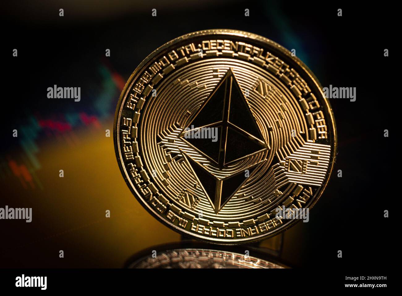 Golden Ethereum coin token with candlestick chart background. Digital ...