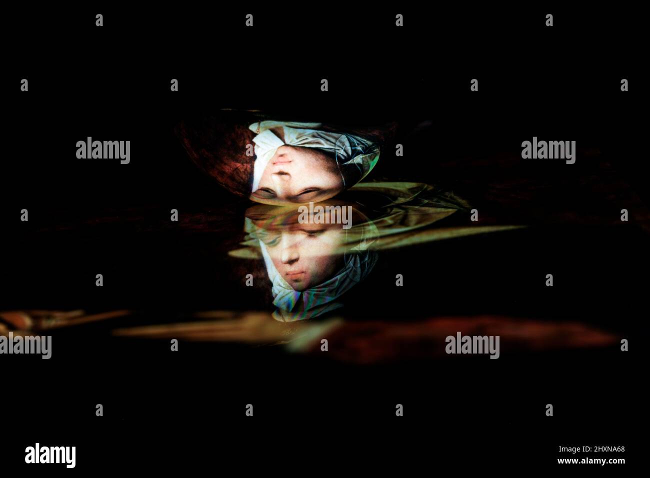 A classic renaissance portrait reflect from a tablet surface into a ...