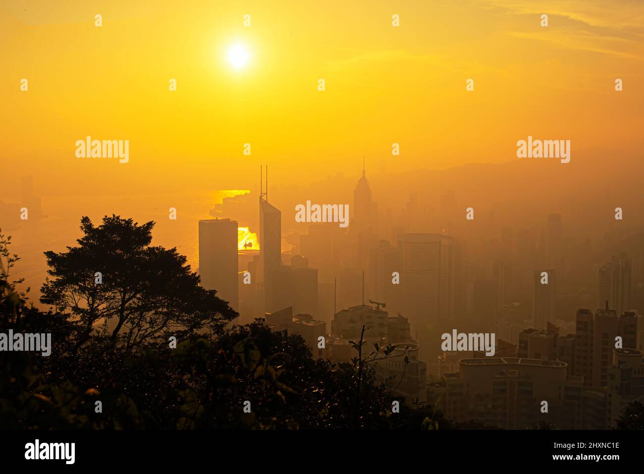 Skyline of Hong Kong (China) at dawn with the sun starting raising on ...