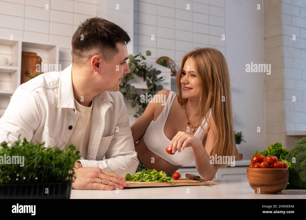 Married couple cooking at home. Beautiful woman and handsome man making ...