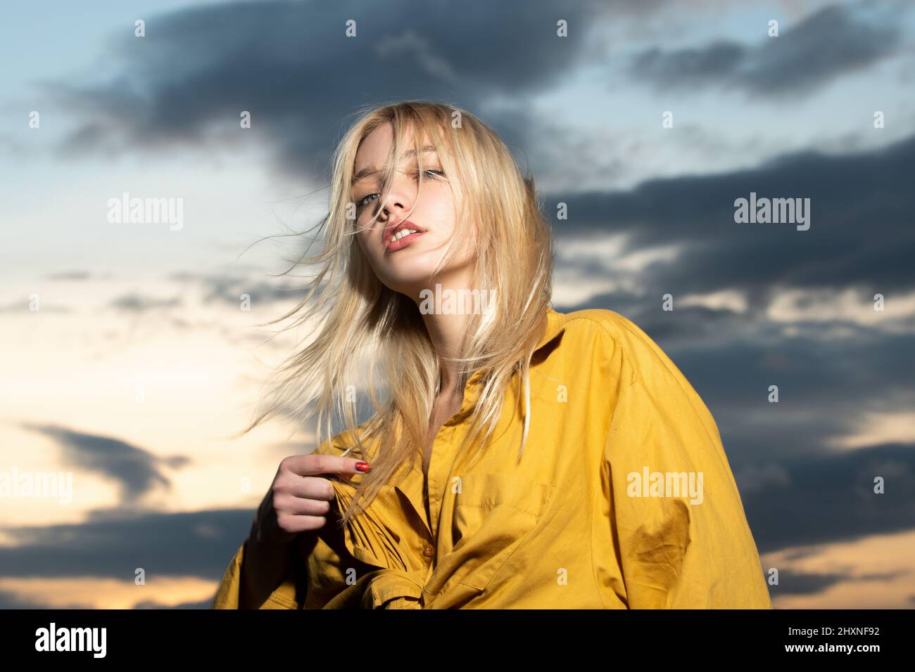 Sensual blonde woman, beautiful girl on dramatic sky. Beautiful girl ...