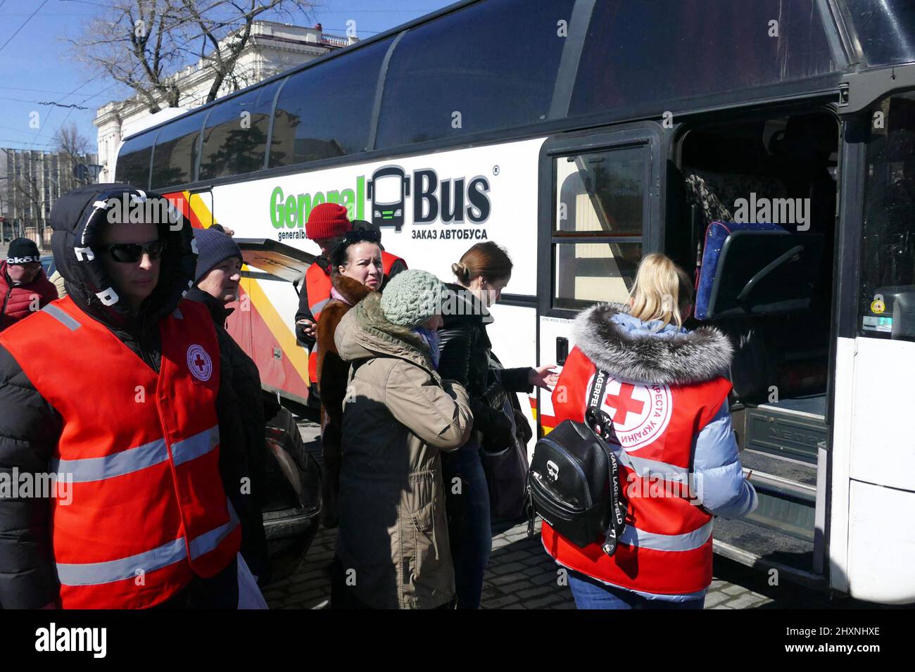 Odesa, Ukraine, March 12, 2022. People stand next to an evacuation bus ...