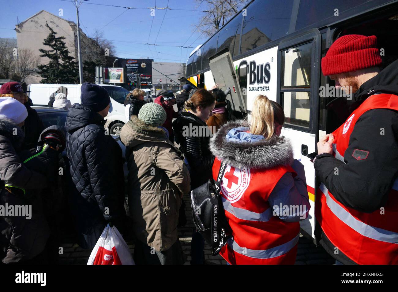 Odesa, Ukraine, March 12, 2022. People stand next to an evacuation bus ...