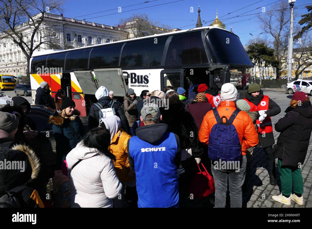 Odesa, Ukraine, March 12, 2022. People stand next to an evacuation bus ...