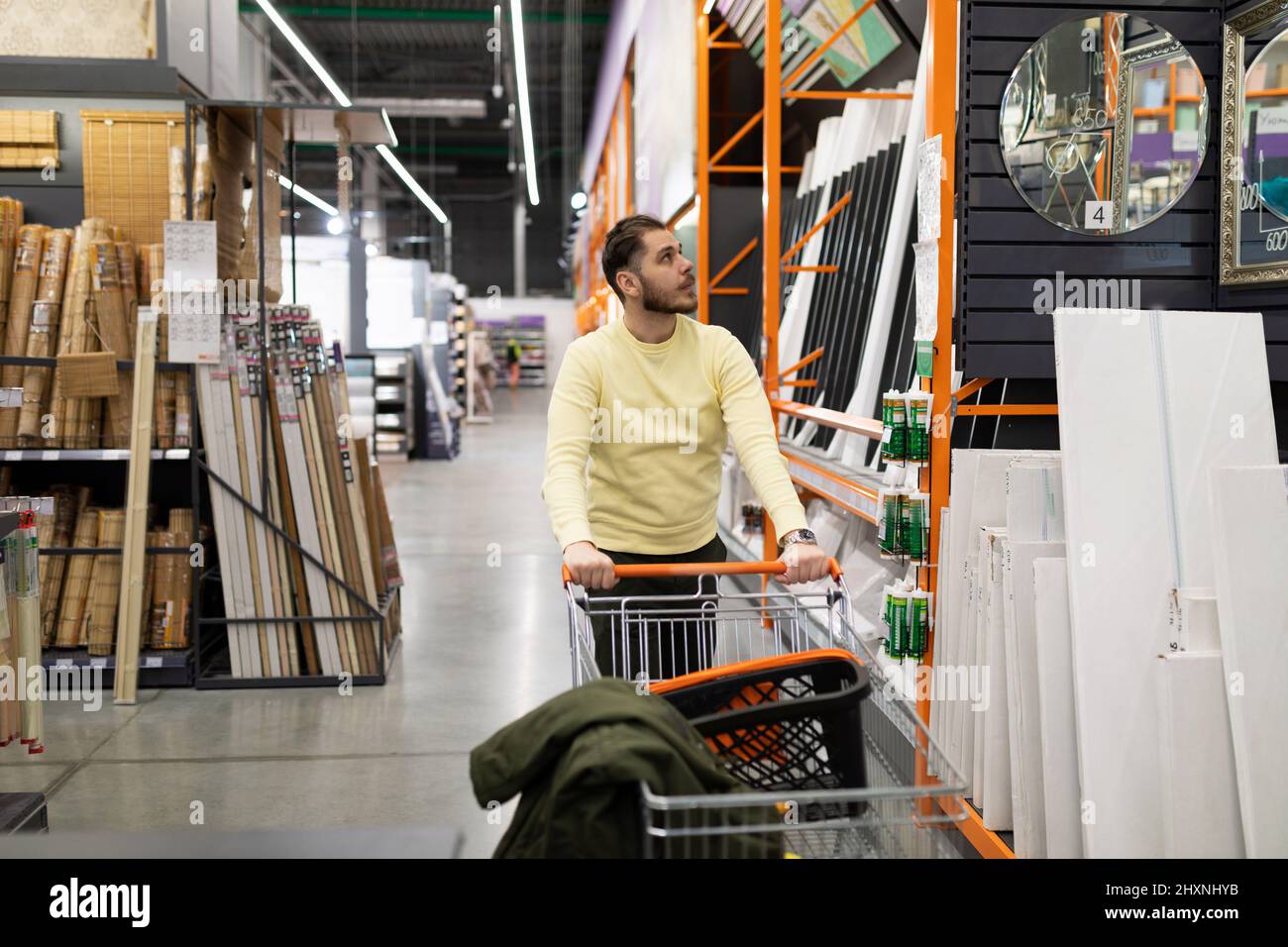 shoppers in a hardware store next to a showcase with bathroom and hall ...