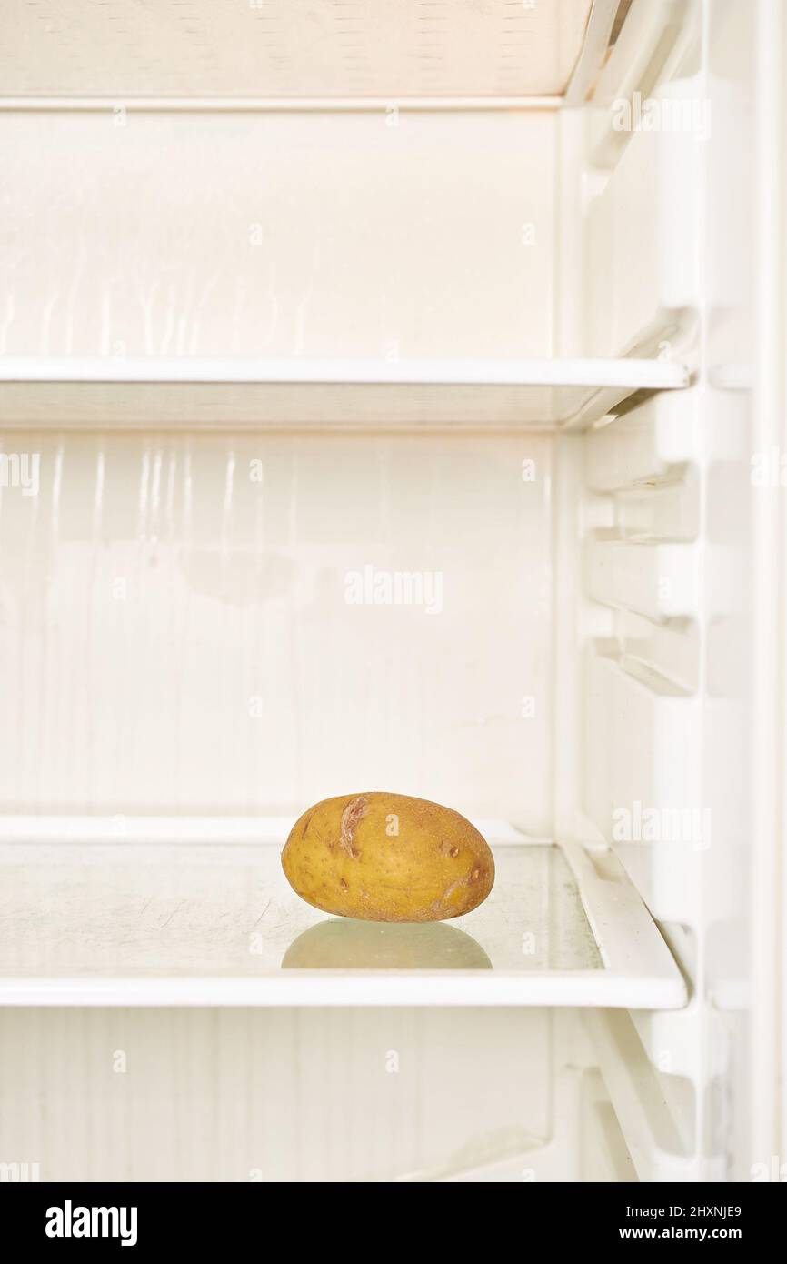 Spoiled potato is on the shelf of an empty refrigerator Stock Photo - Alamy