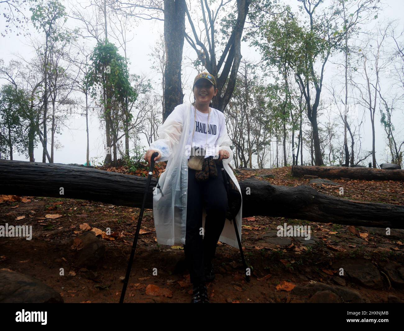 Traveler thai women people wear raincoat walking trail or hiking in ...