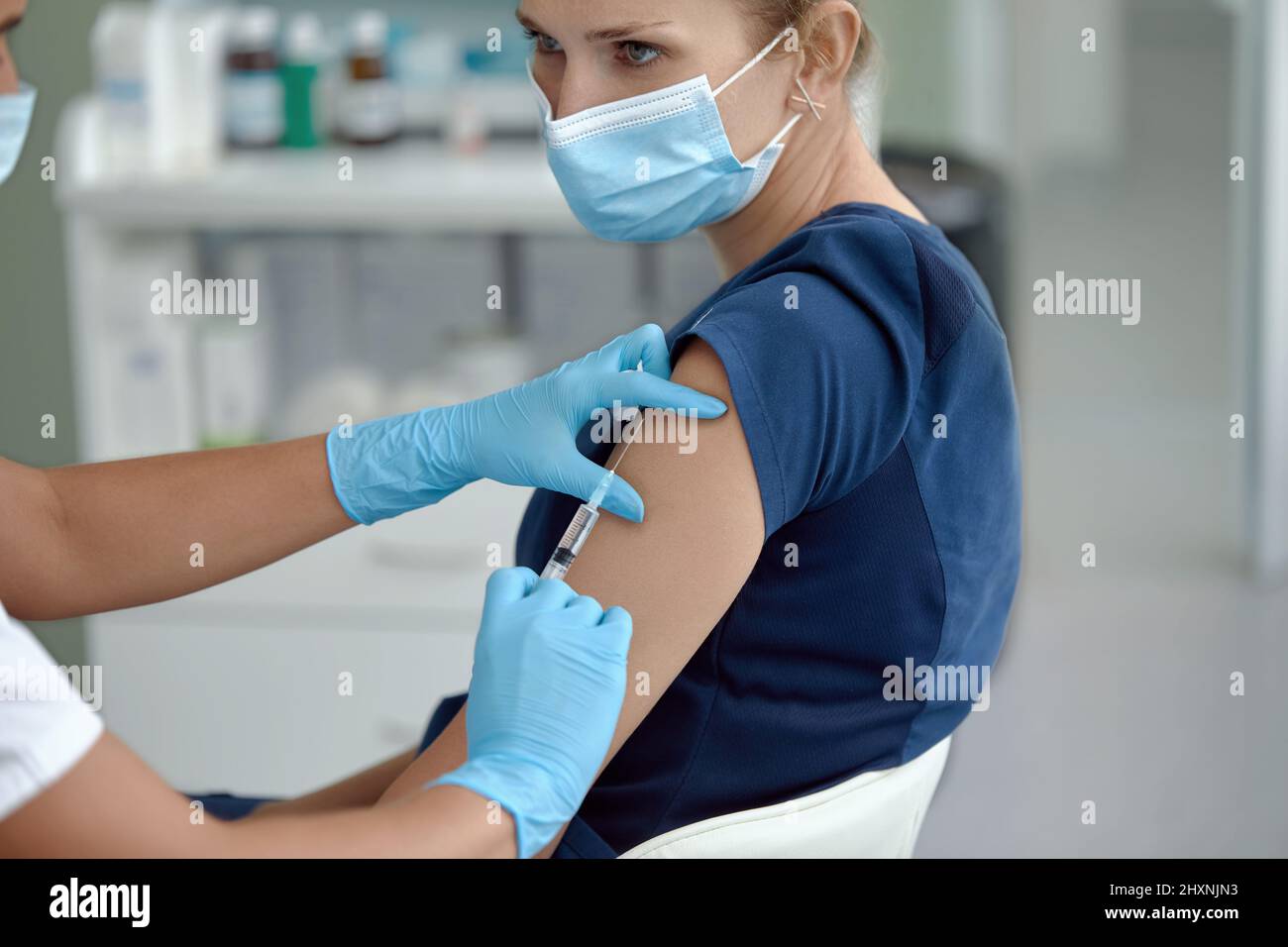 woman doctor holding syringe making covid 19 vaccination injection dose ...