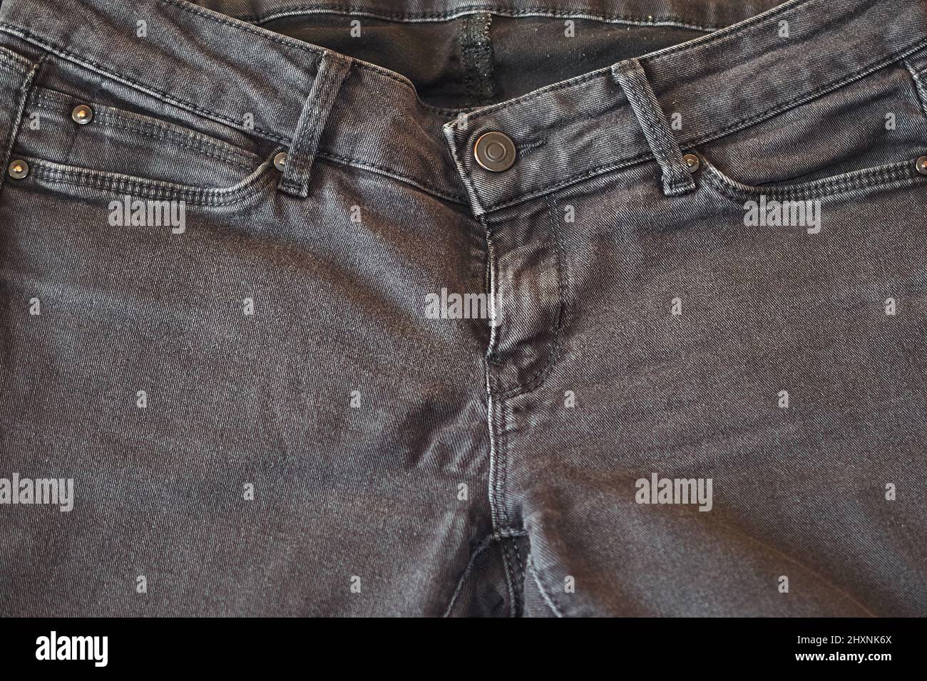 The upper part of old worn black jeans with pockets Stock Photo - Alamy
