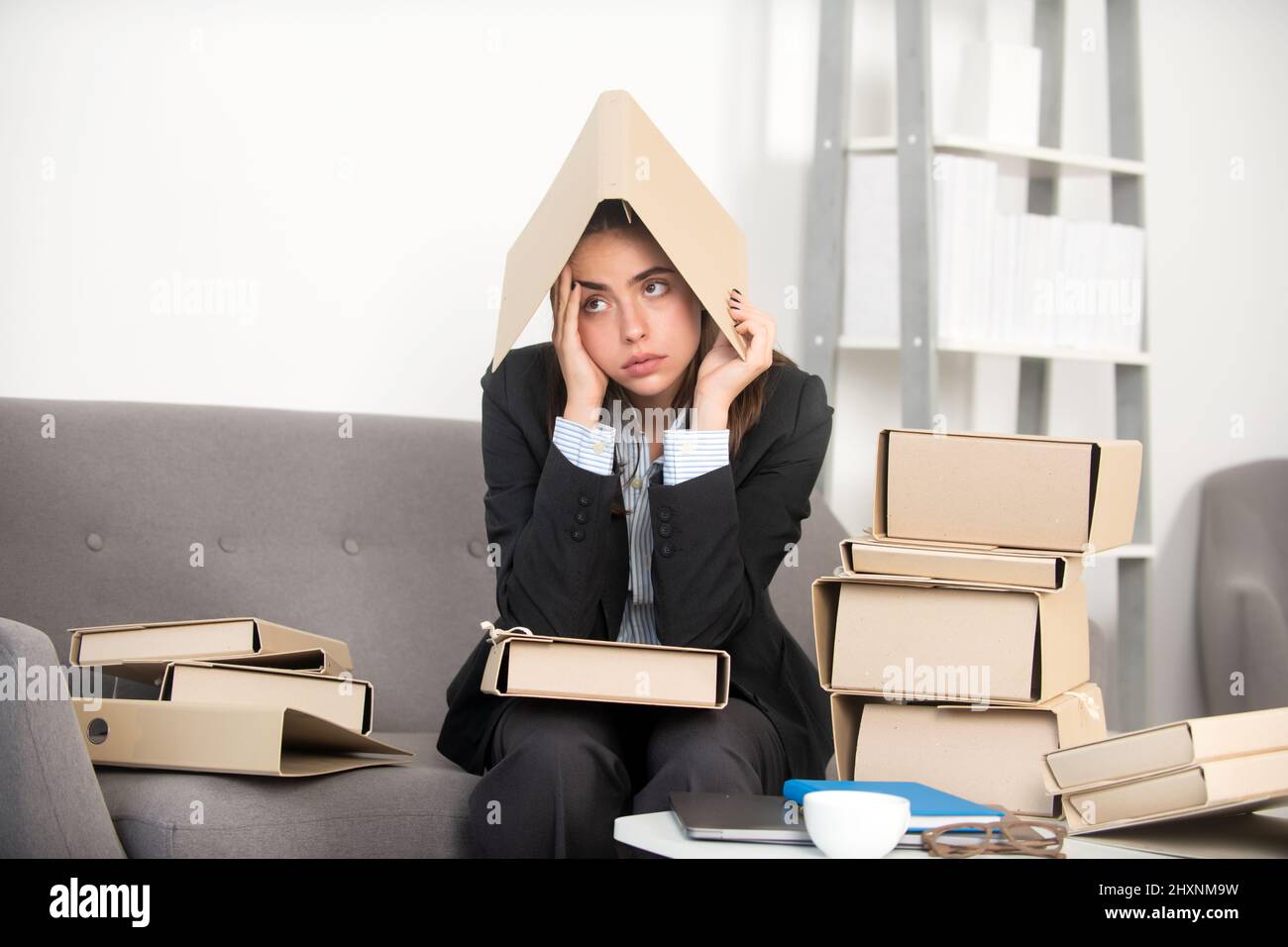 Sad secretary girl with folder on head, stressed overworked ...