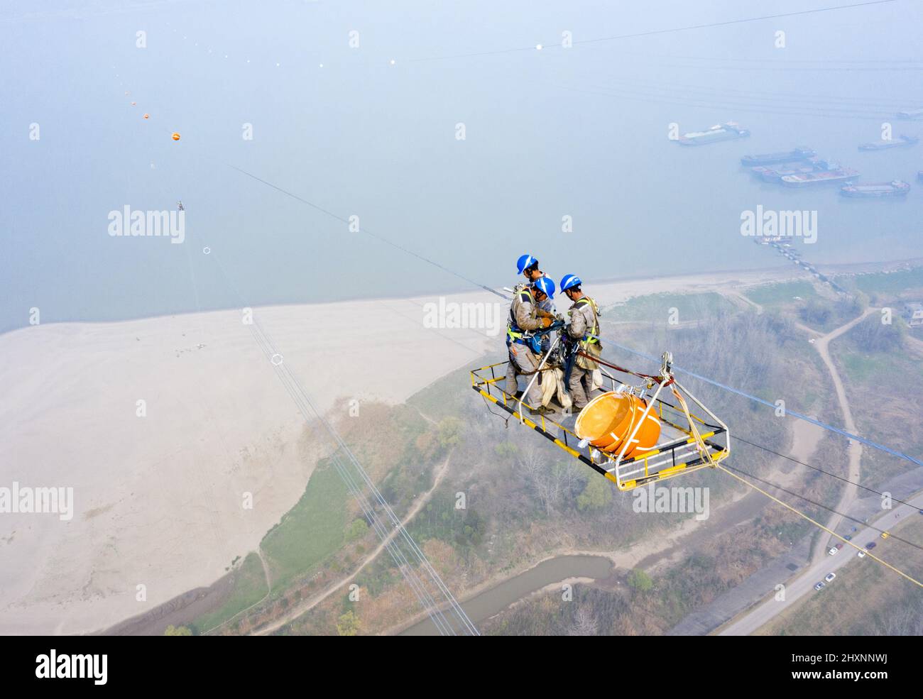 WUHU, CHINA - MARCH 14, 2022 - Construction workers cross the Yangtze ...