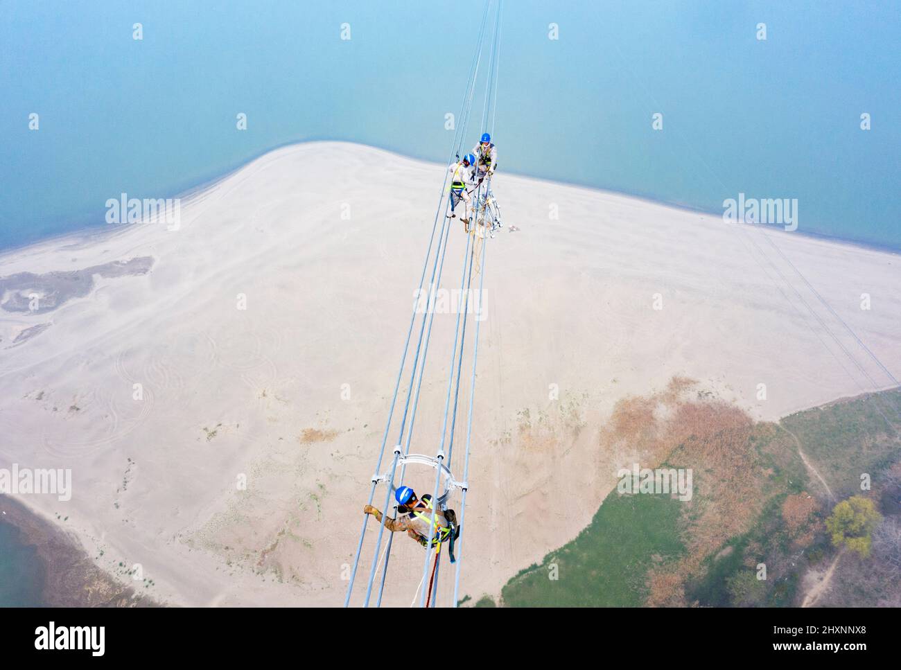 WUHU, CHINA - MARCH 14, 2022 - Construction workers cross the Yangtze ...