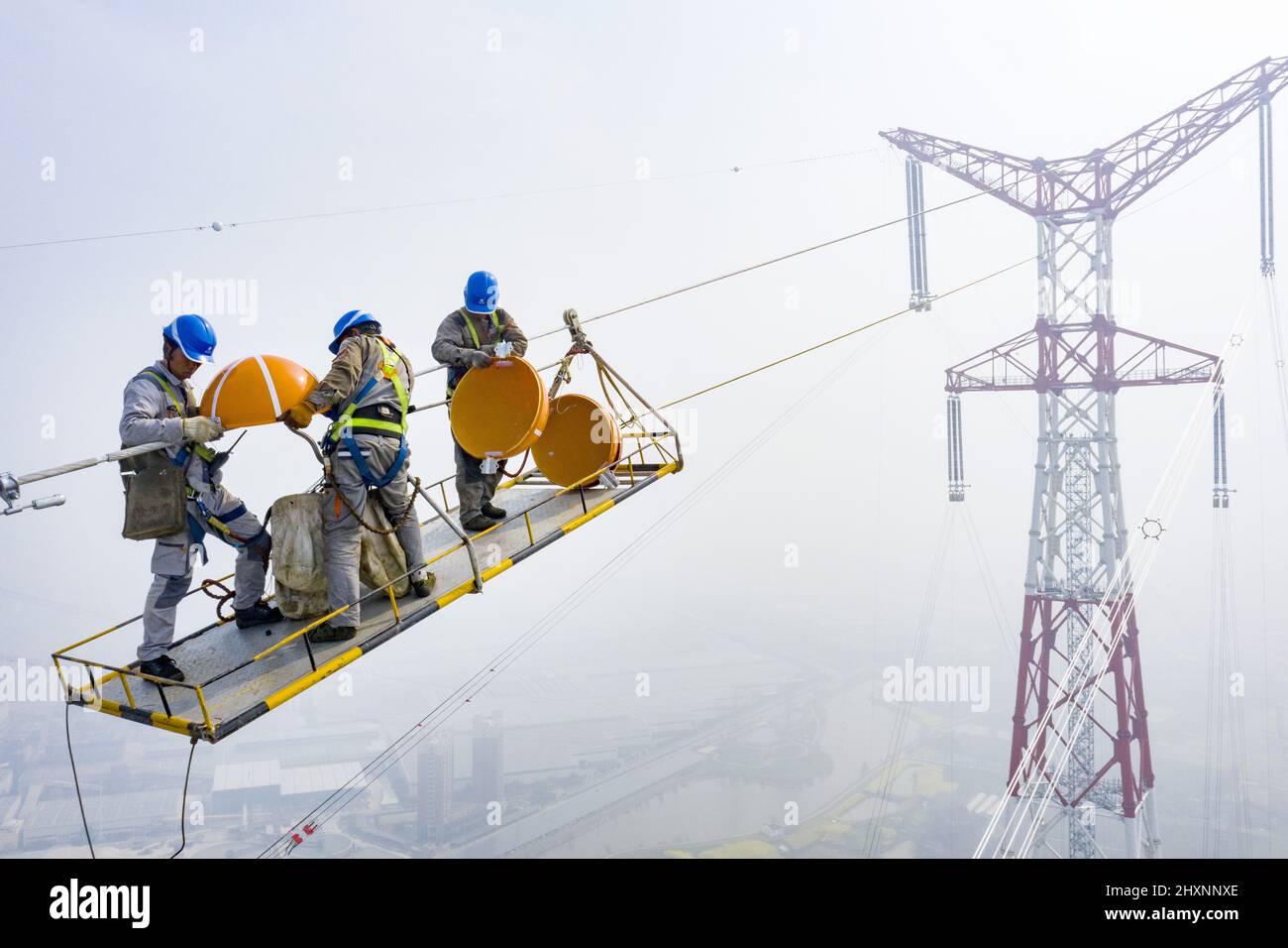 WUHU, CHINA - MARCH 14, 2022 - Construction workers cross the Yangtze ...