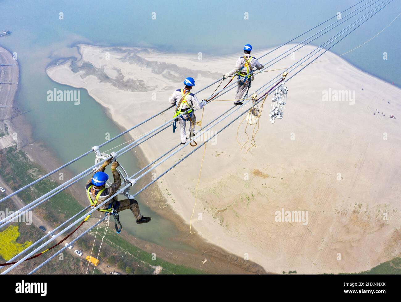 WUHU, CHINA - MARCH 14, 2022 - Construction workers cross the Yangtze ...