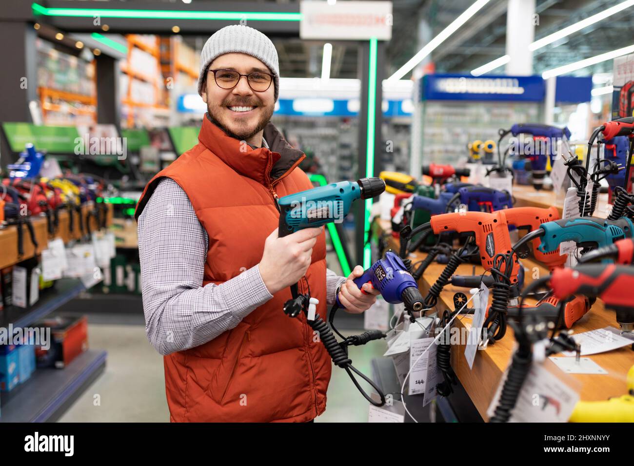 a satisfied customer purchases an electric drill and screwdriver in an ...