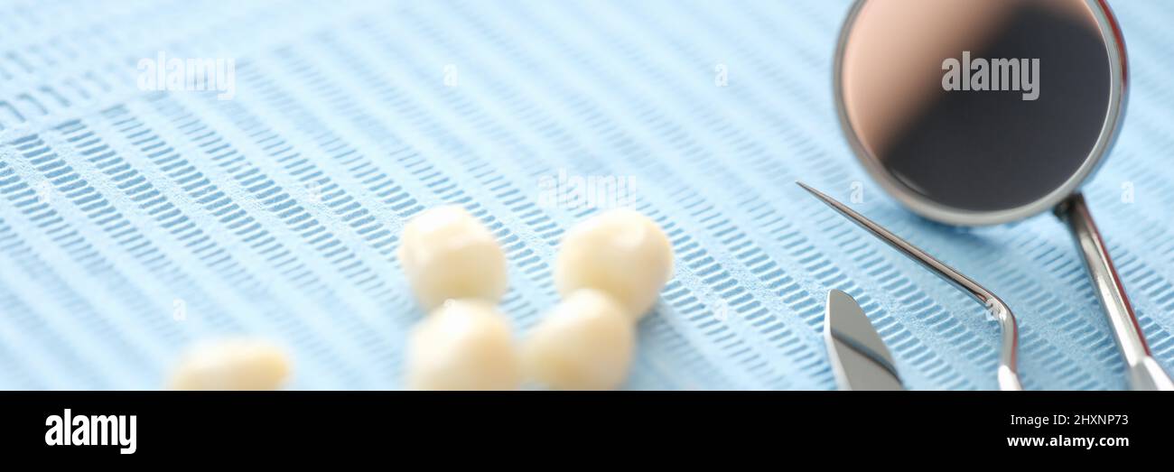 Dentures and dental instrument on table closeup Stock Photo - Alamy
