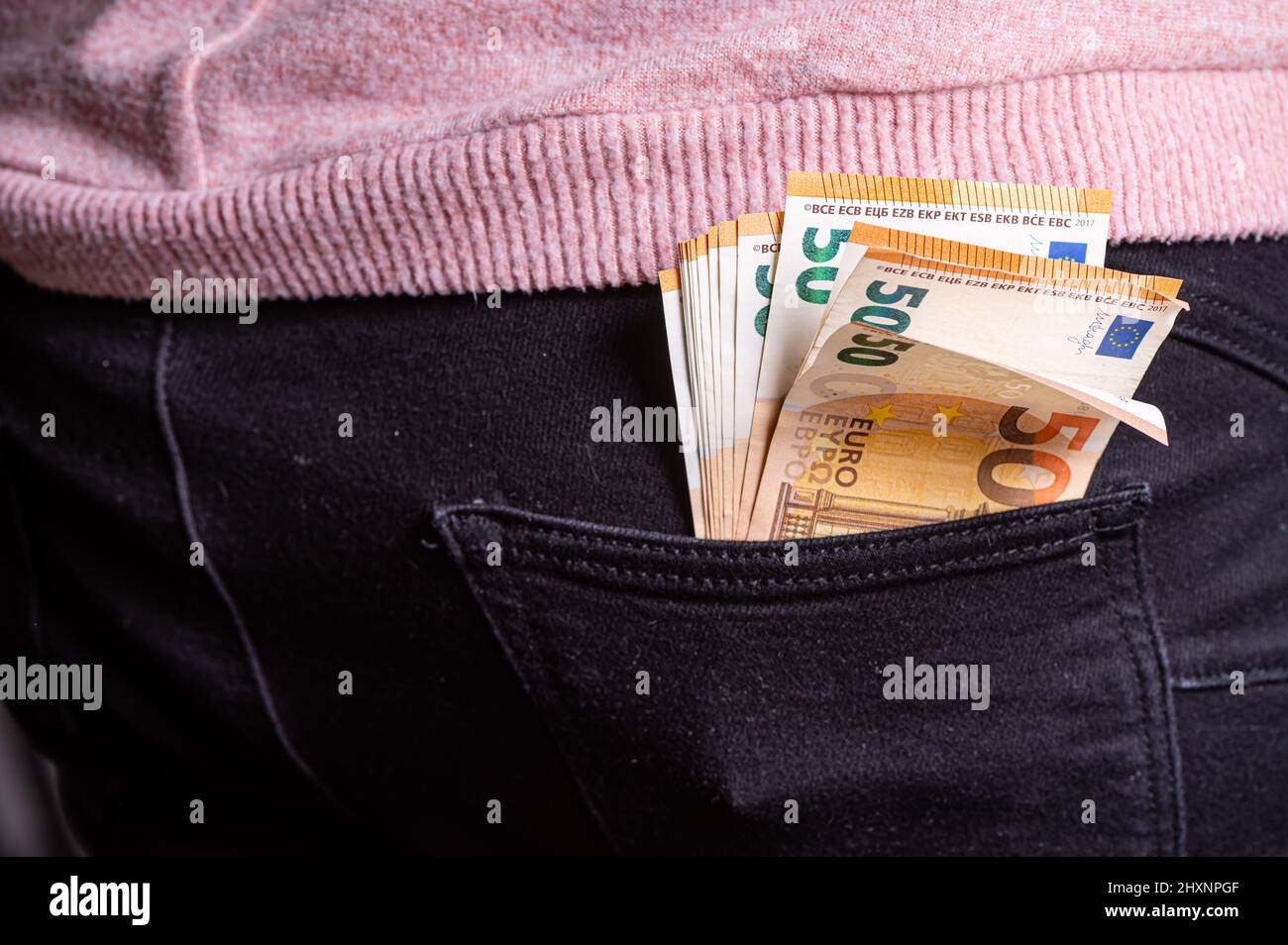 Euro banknotes in jeans back pocket. Concept of rich people, saving or ...