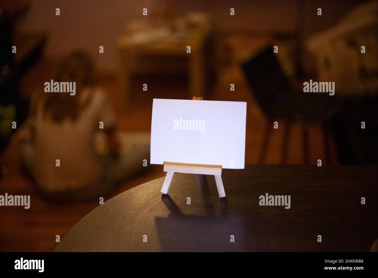 White sign for inscription. Small blank poster mounted on wood molar ...