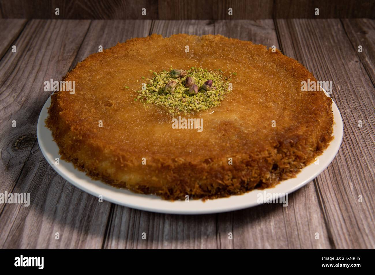 Delicious Traditional Dessert Knafeh with cheese and pistachios and ...