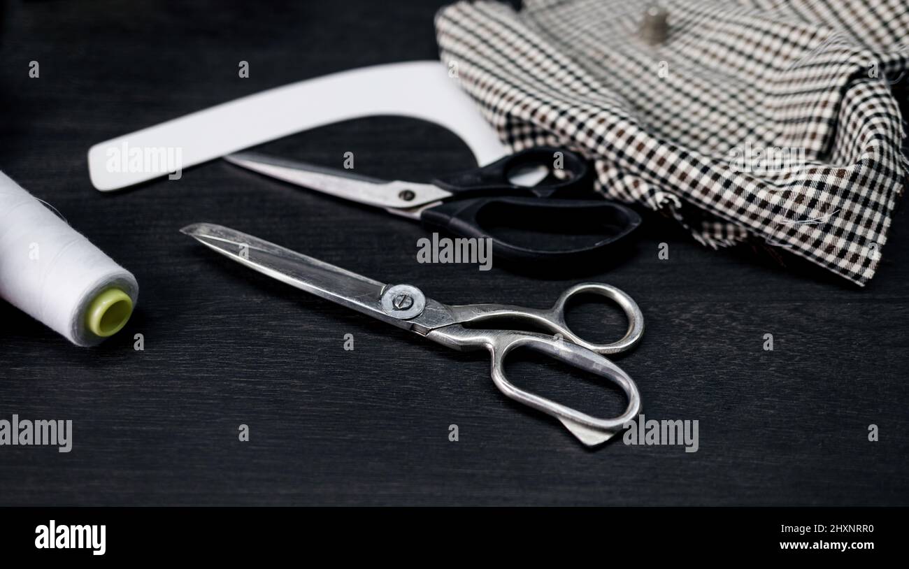 Items for sewing: needle, scissors, threads and textile Stock Photo - Alamy