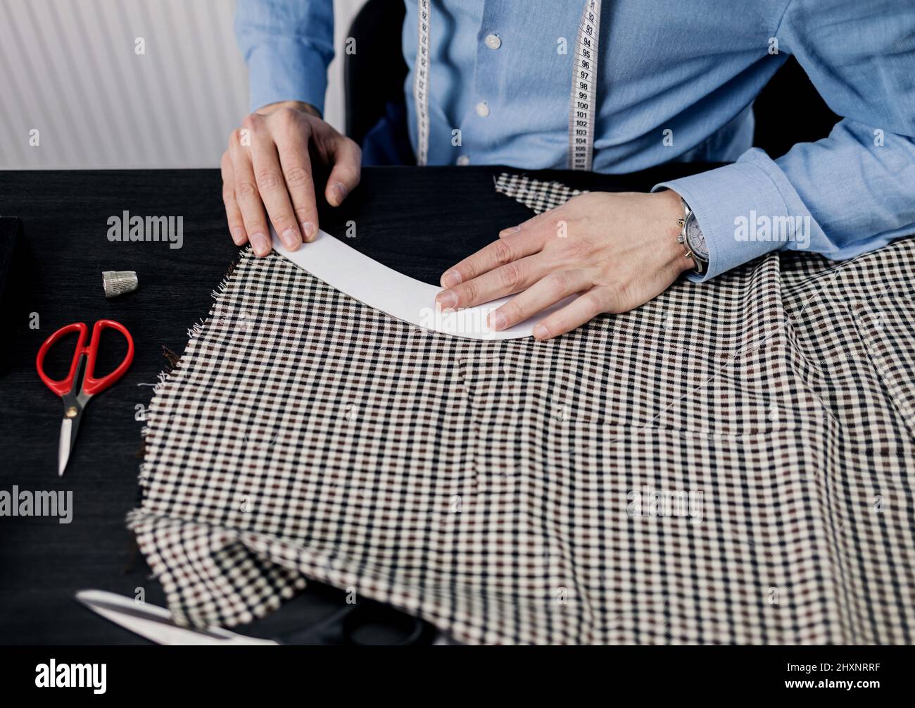 tailor working with sewing pattern in atelier. individual tailoring ...