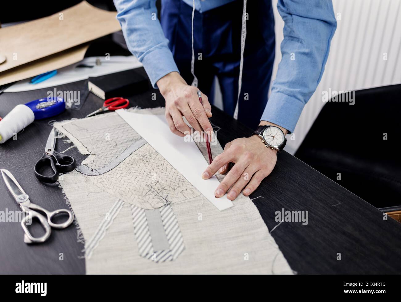 tailor's work table with cloth for suit cut and marked up for sewing ...