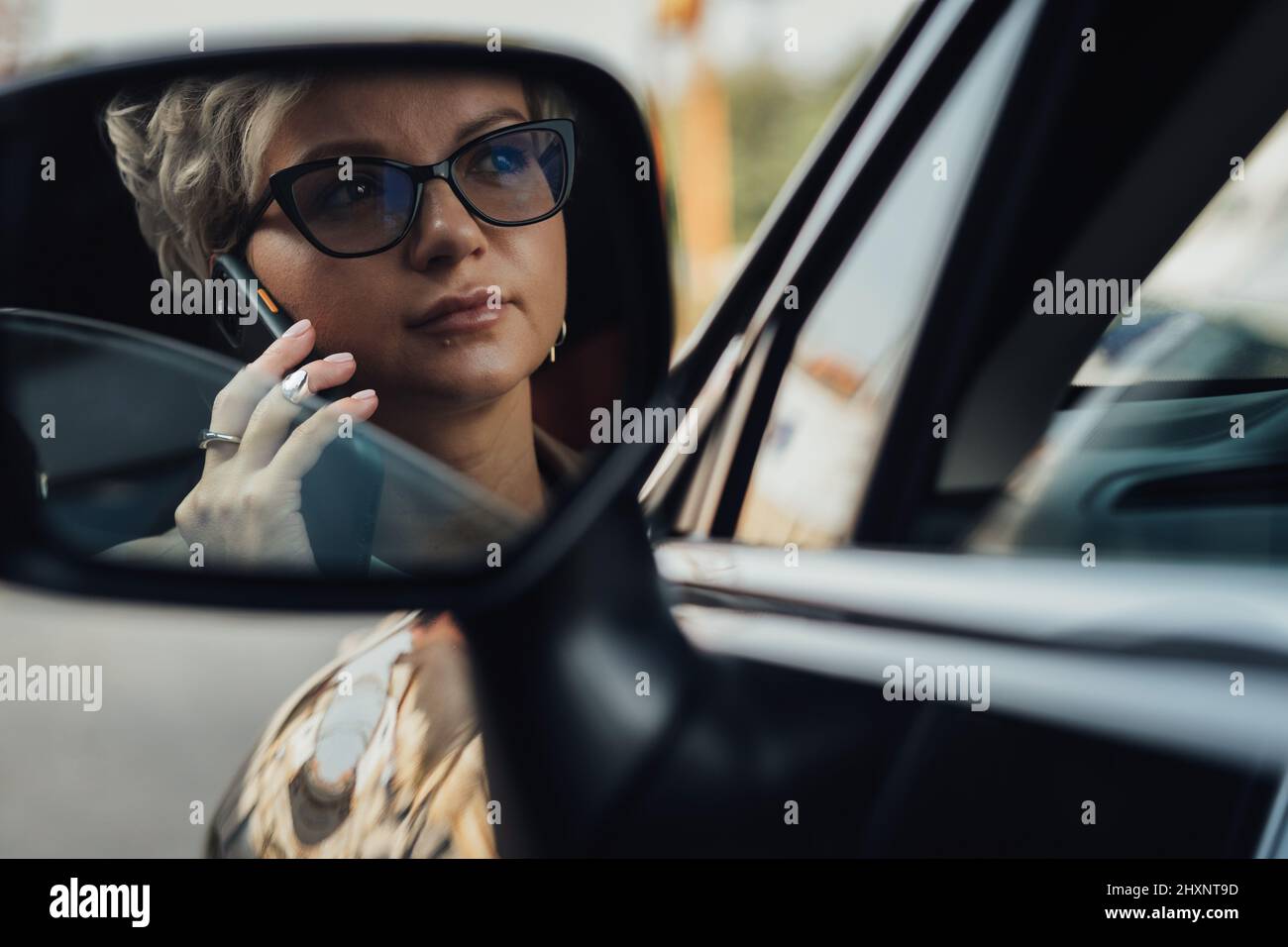 Stylish Woman in Glasses Talking on a Phone While Driving Car, View ...